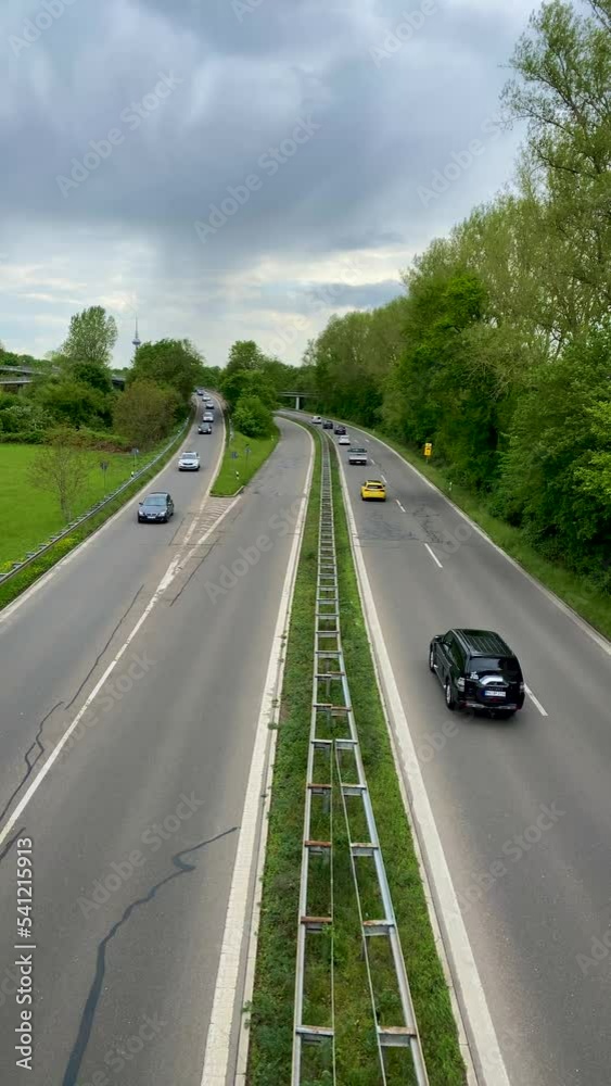 Driving on the highway. Cars on dual carriageway covered with trees ...
