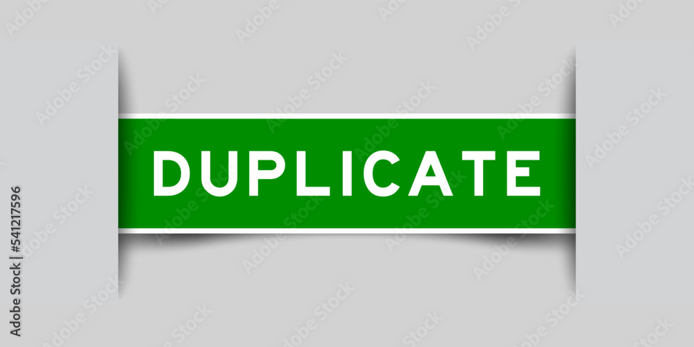 Inserted green color label sticker with word duplicate on gray ...