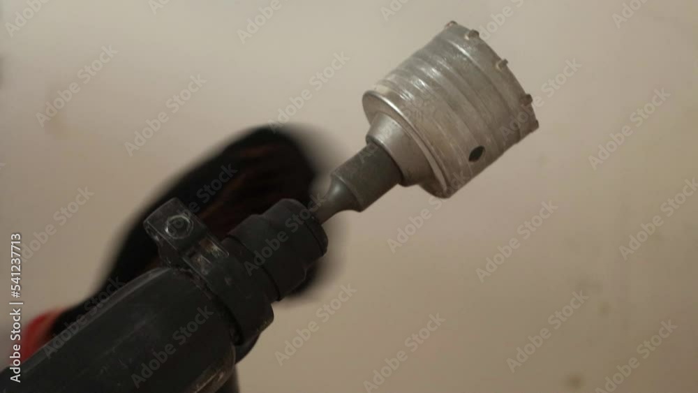 Demonstration of the work of the perforator. Close-up. The hands of a ...