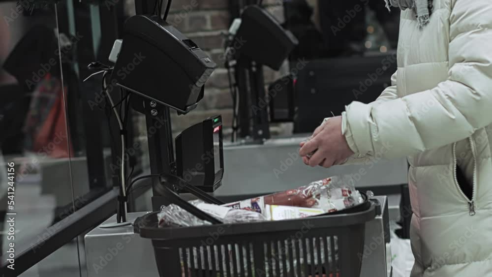 Buyer scans products through barcode scanner at self-service checkout ...
