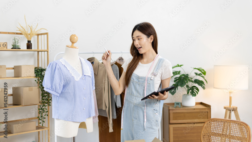 Professional designer sketching outfits through tablet in the design ...