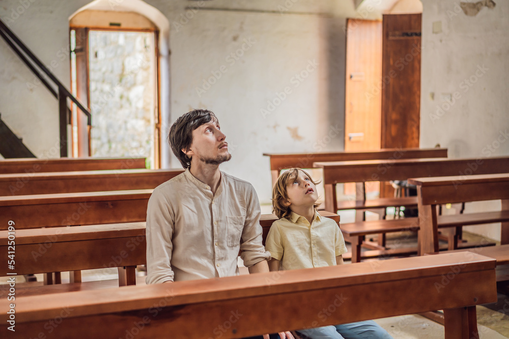 Christian dad tells his son Bible stories about Jesus sitting in kirk ...