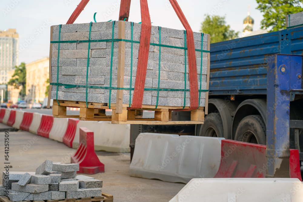 Delivery and unloading of pallets with granite paving stones using a ...