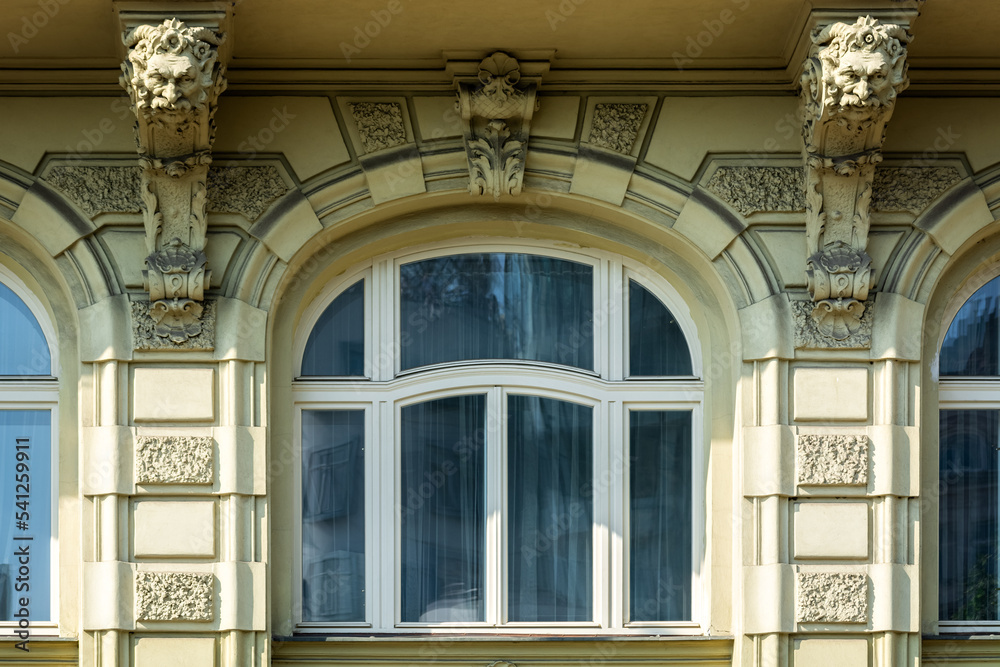 Arched window with a white frame sculpture and stucco reflection of ...