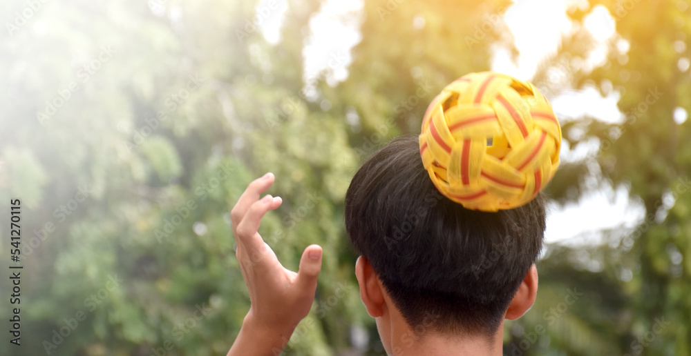 Young southeast asian male sepak takraw player using his right hand to ...