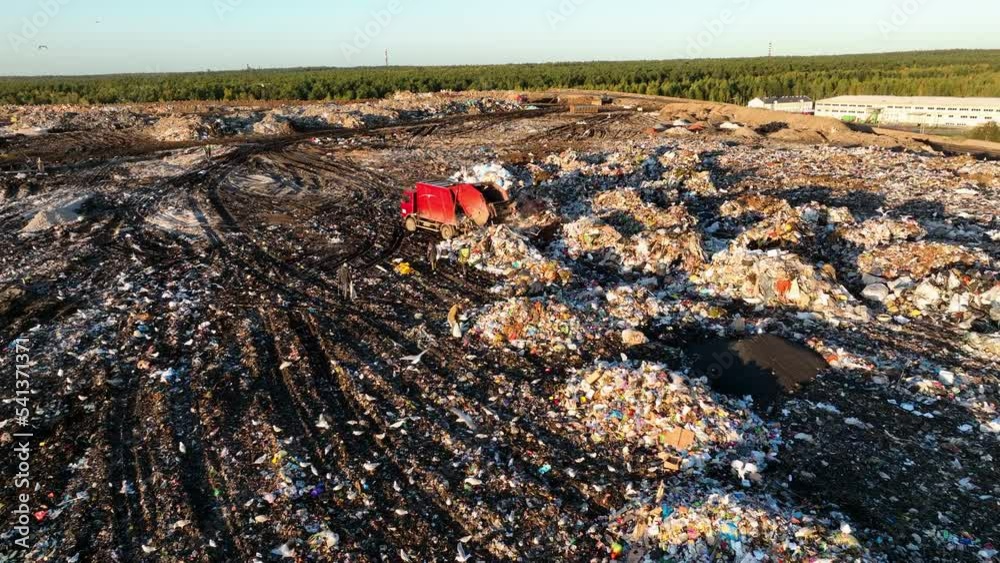 Garbage truck unloads rubbish. Landfill with solid household waste ...
