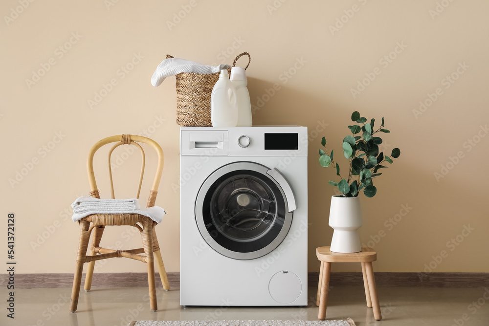 Interior of laundry room with washing machine, chair and stool Stock ...
