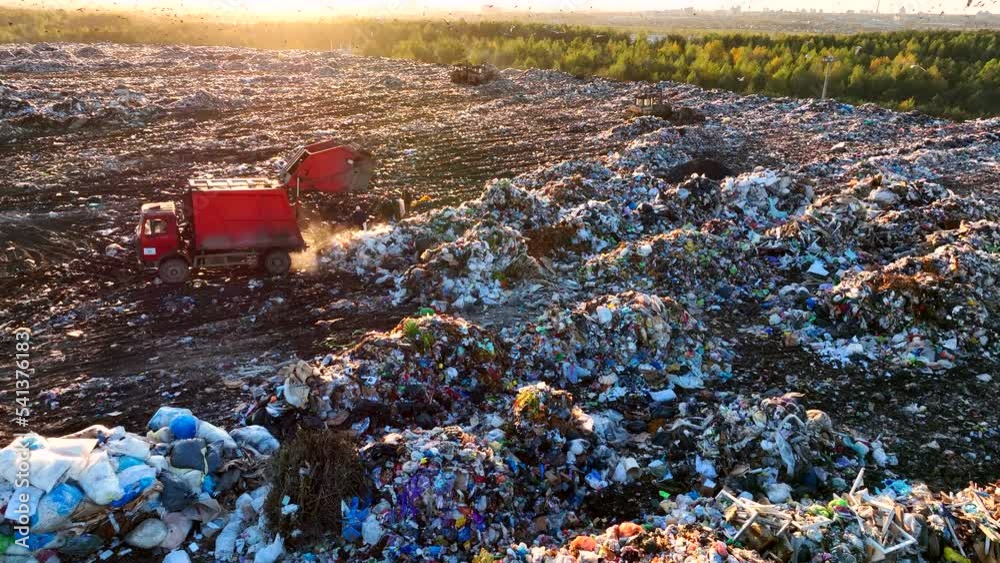 Garbage truck unloads rubbish. Landfill with solid household waste ...