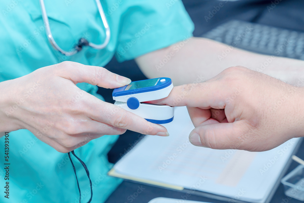 Doctor checking oxygenation with fingertip pulse oximeter. Saturation ...