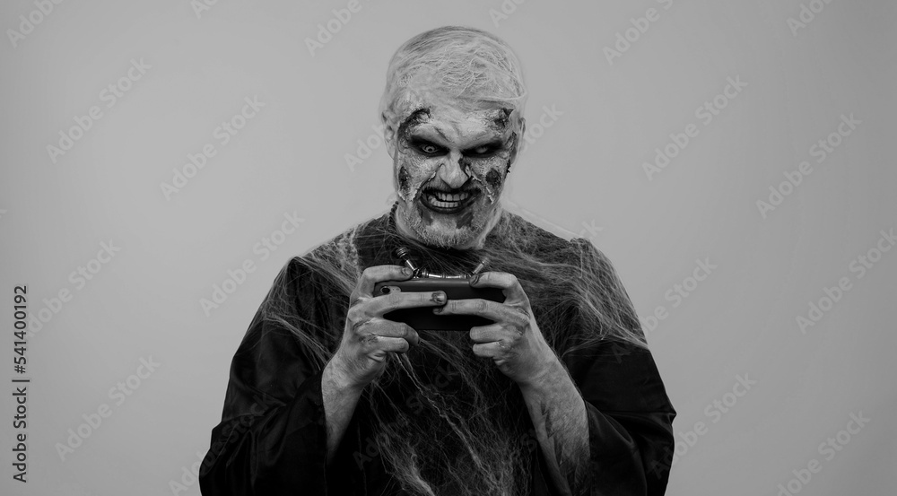 Sinister man with horrible scary Halloween zombie makeup ...