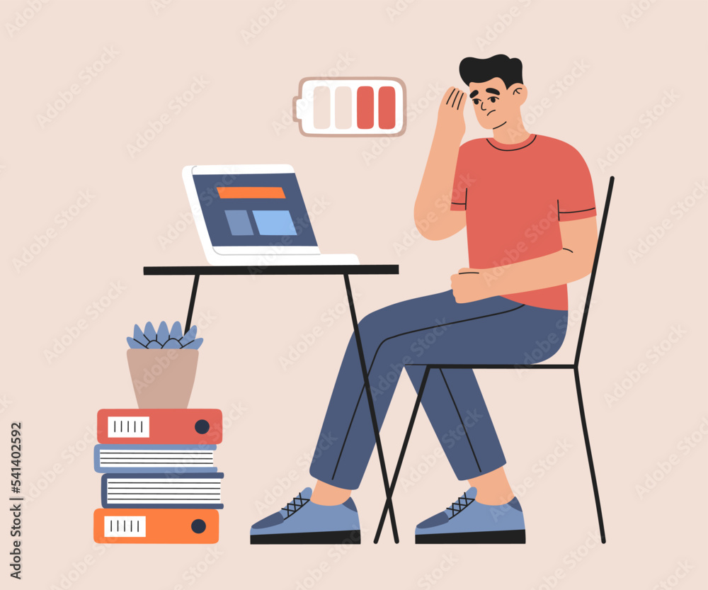 Tired man with low energy sits by the table with laptop, overworked and ...