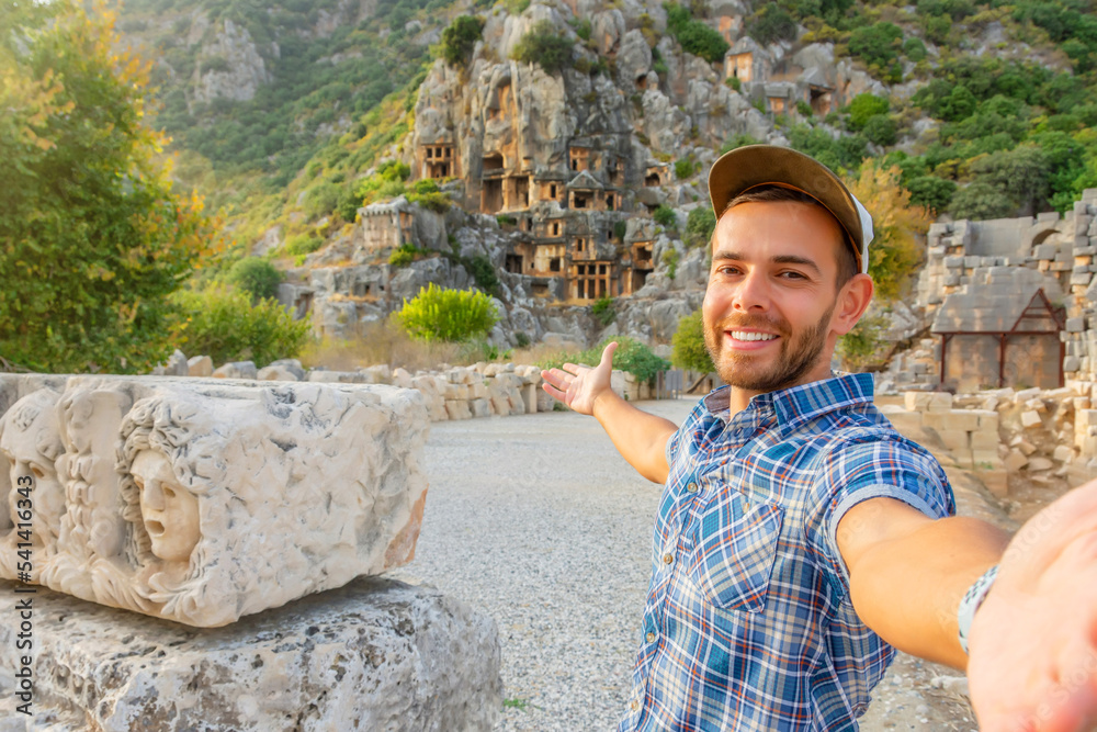 Swarthy caucasian european guy in plaid shirt smiles rejoices, takes ...