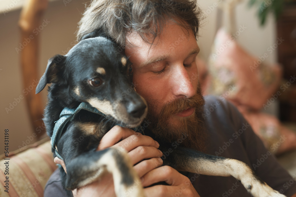 Cute love between a man and a dog; rastafarian dreadlocks man holding ...