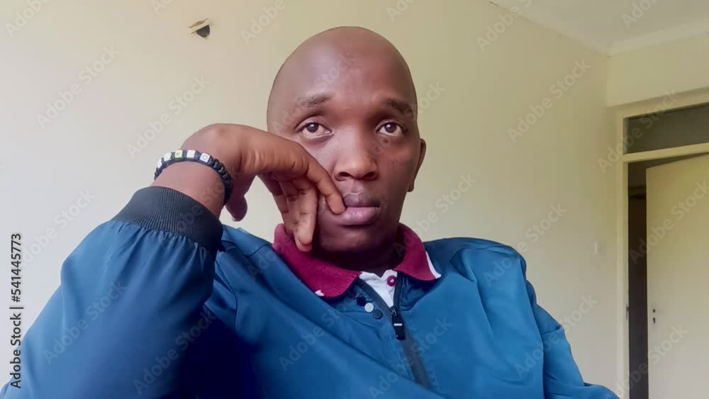 A depressed African man thinking deeply holding his nose. Depression ...