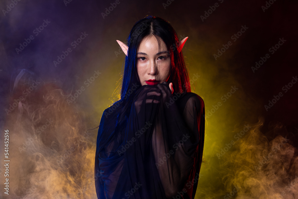 Fairy woman elf queen in black fantasy rope long dress cast spell ...