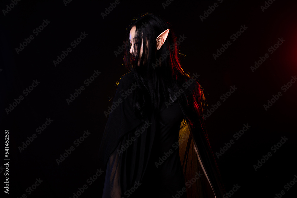 Fairy woman elf queen in black fantasy rope long dress cast spell ...