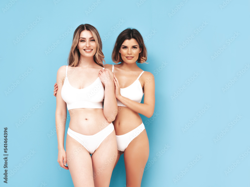 Fashion Portrait Of Two Young Beautiful Women Attractive Carefree Models Wearing Pure White
