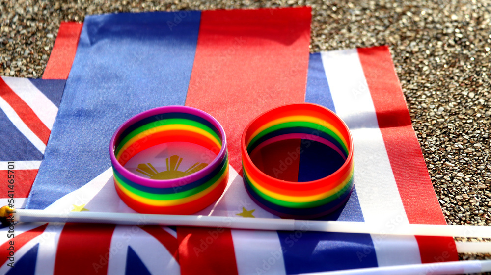 LGBTQ flag with countries flags are put on the floor with lgbt wrist ...