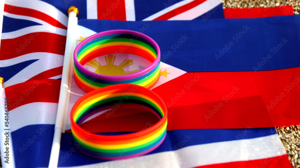 LGBTQ flag with countries flags are put on the floor with lgbt wrist ...