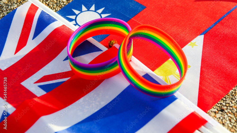 LGBTQ flag with countries flags are put on the floor with lgbt wrist ...