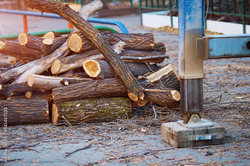 Sawn branches and tree trunks. The hydraulic support of the telescopic ...