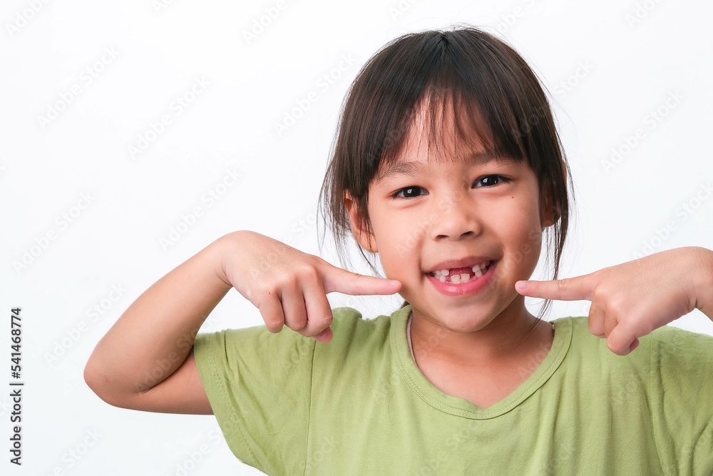 Portrait of an Asian girl with broken upper baby teeth and first ...