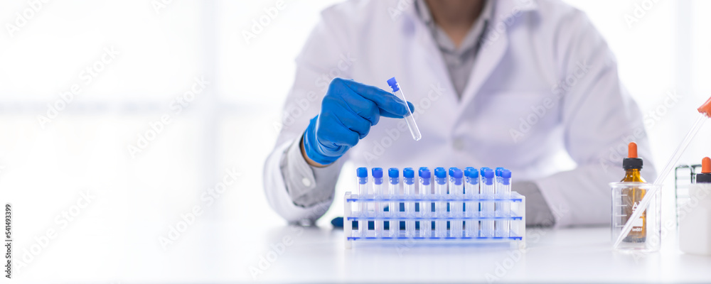 Serious concentrated female microbiologist in sterile clothing and ...