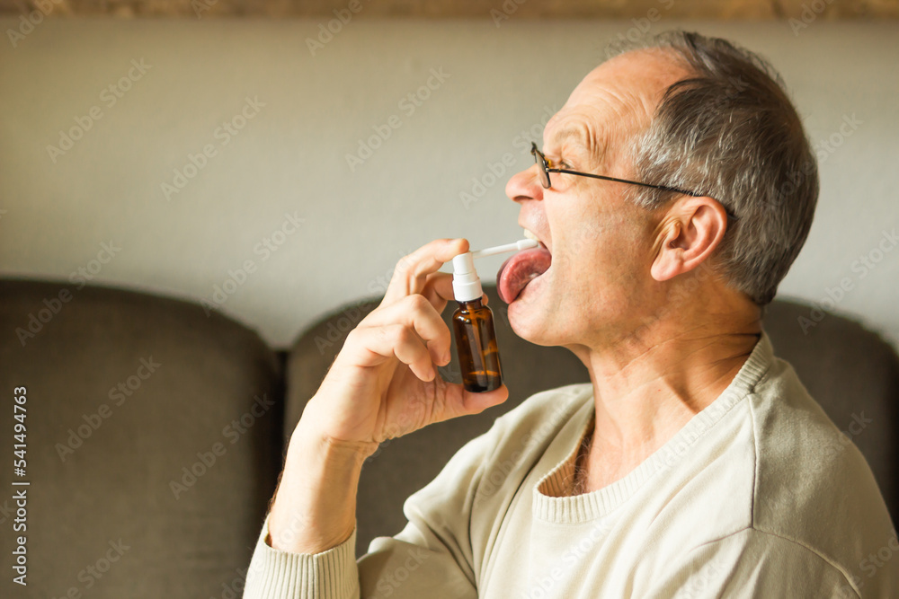 Sick caucasian senior man with open mouth and long tongue using a ...