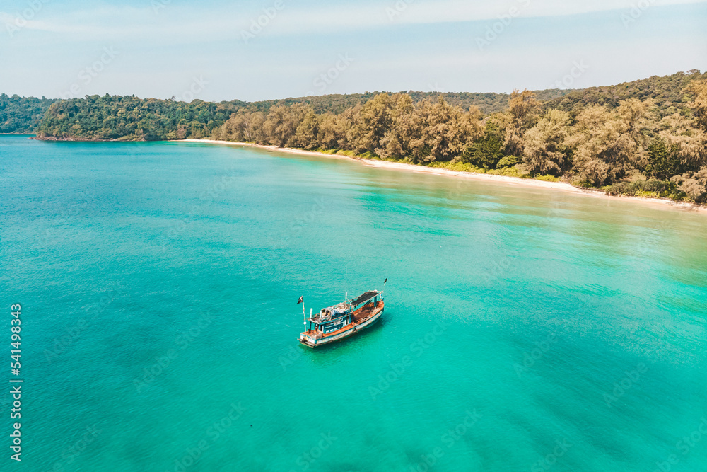 Fishing boats in the crystal clear turquoise water of sea. Coast of ...