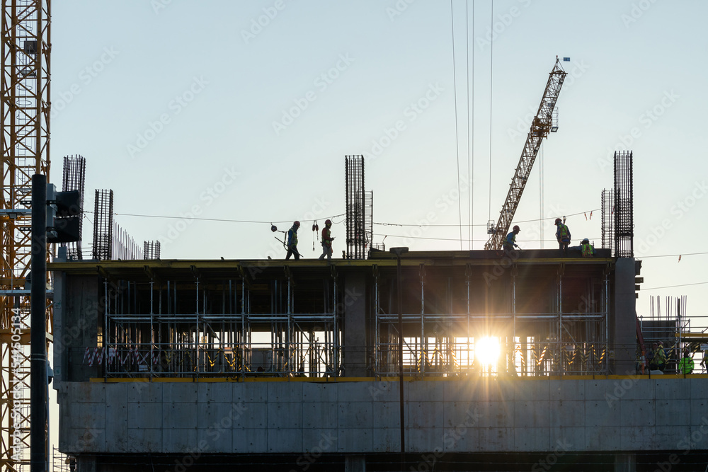 Builder workers working on construction site and sunset,beam, steel ...