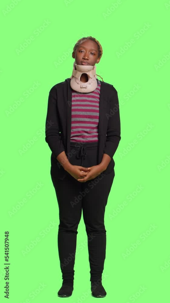 Vertical video: African american girl wearing cervical collar after ...