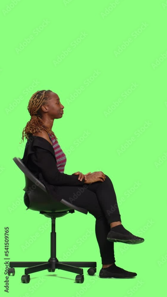 Vertical video: Young person on chair sitting and posing over ...