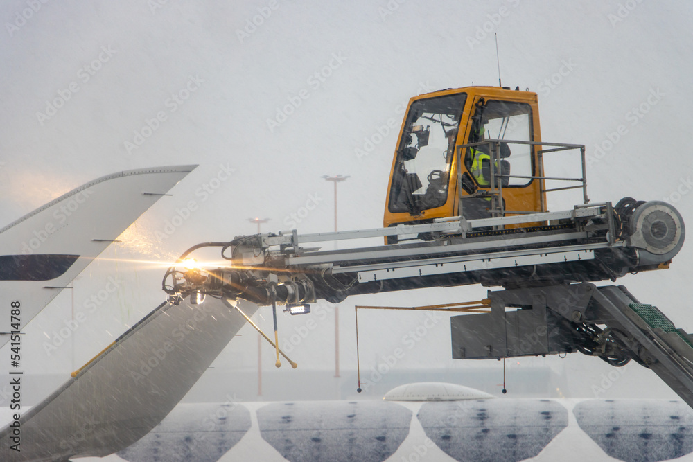 A aircraft de-icing (anti-icing) using modern de-icing technology with ...