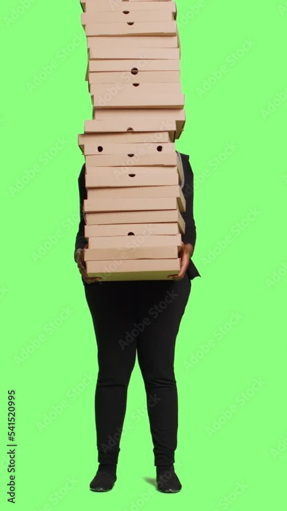 Pizzeria restaurant worker delivering boxes of pizza in pile, carrying ...