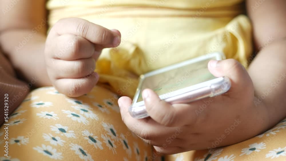 Child girl watching cartoon on smart phone Stock Video | Adobe Stock
