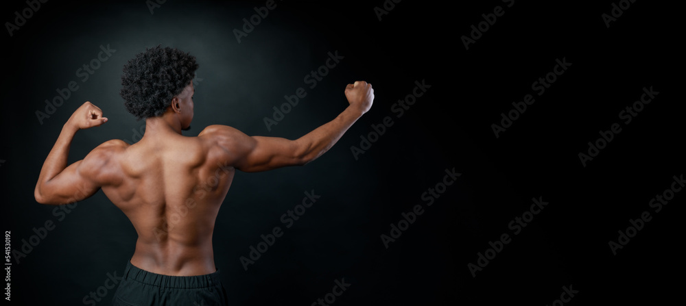 Sportsman showing his back muscles. Athlete flexing muscles. Black ...