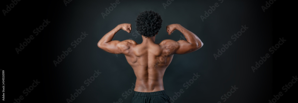 Sportsman showing his back muscles. Athlete flexing muscles. Black ...