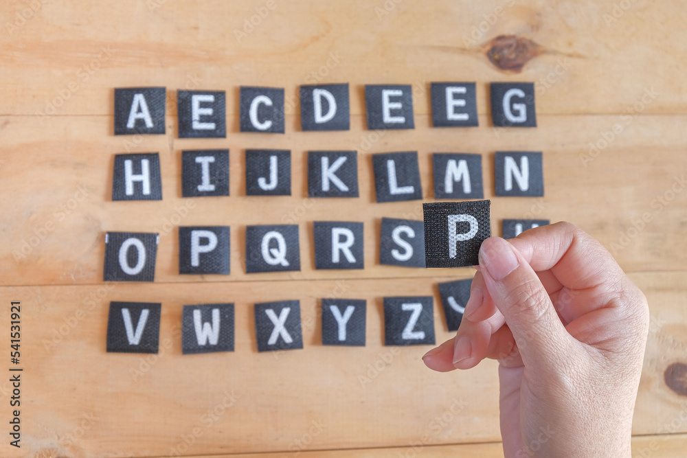Hand hold a English alphabet letters . Stock Photo | Adobe Stock