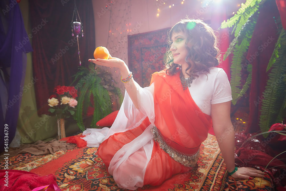 Beautiful European girl looking like Arab woman in red room with rich ...