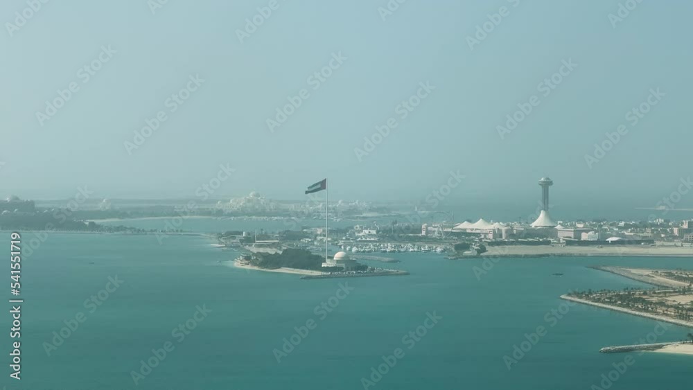 United Arab Emirates flag waving around Abu Dhabi city landmarks ...