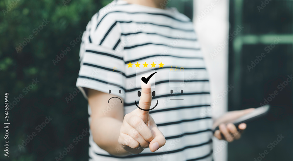 Woman client pressing smiley face emoticon on virtual touch screen ...