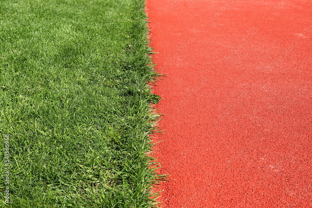 Grass and red ground at a Stadium. Small part of the whole area. Bålsta ...