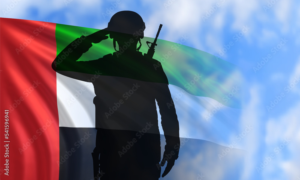 Silhouette Of A Solider Saluting on the background of sky and UAE Flag ...