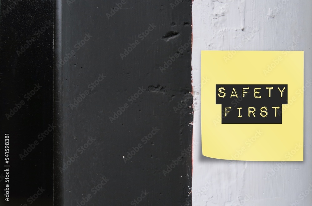 Black copy space painted wall with text on black SAFETY FIRST, concept ...