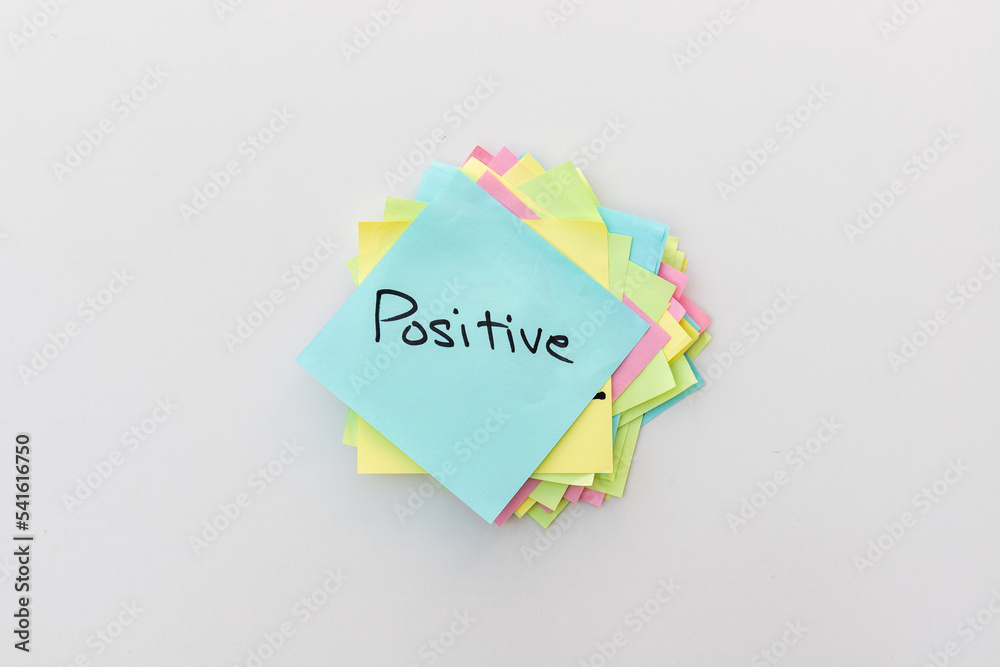 Positive word hand written on a sticky note Stock Photo | Adobe Stock