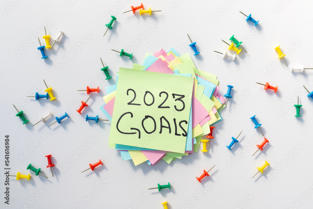 2023 goals hand written on a yellow notepad page with isolated white ...