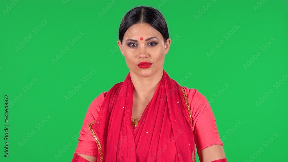 Portrait of a young Indian girl with red bindi dot in national classic ...