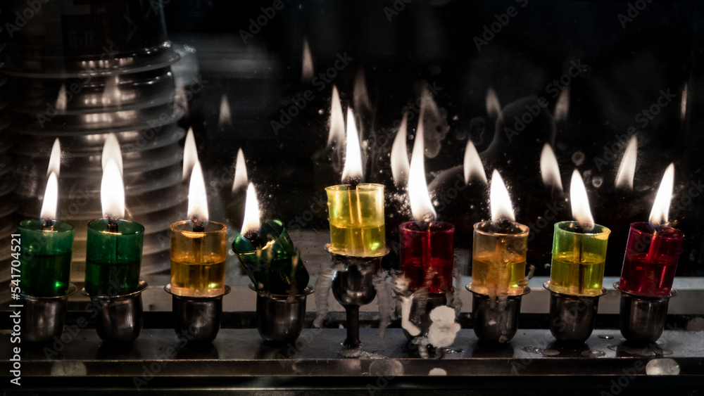 Multi-colored glass vials hold oil and wicks to light the Hanukkah ...