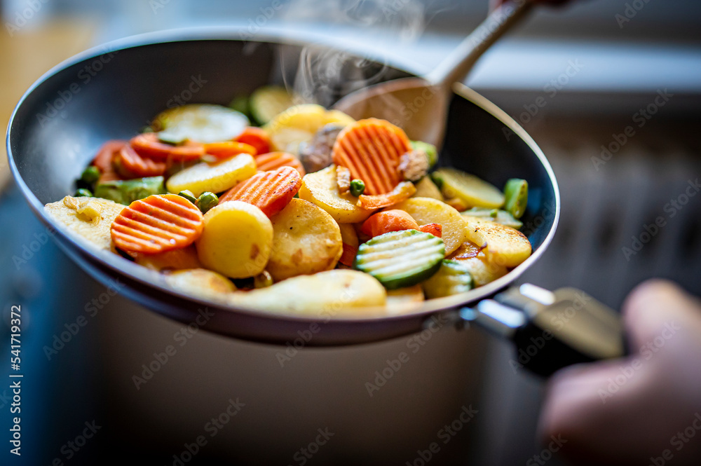 cooking tasty vegetable mix in pan on kitchen Stock-Foto | Adobe Stock