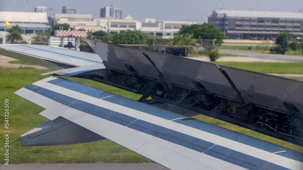 Wing braking of the aircraft on the runway. The wing of an aircraft ...